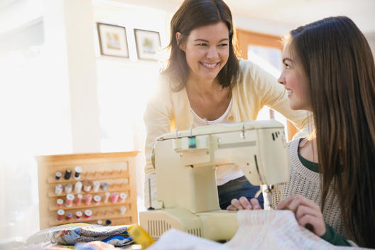 Mother Teaching Daughter How To Use Sewing Machine Stock Image 