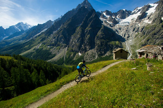 Man riding his mountain bike down a trail in the mountains. - Stock ...