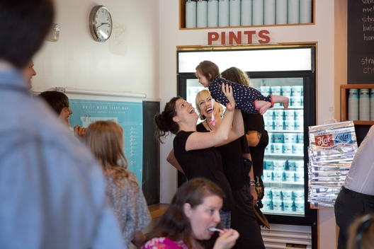 Friends wait in line for ice cream at an upscale ice cream shop in ...