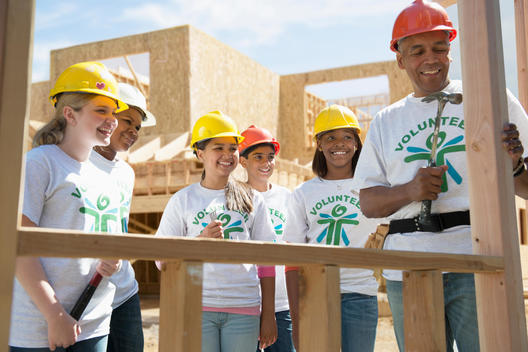 Volunteers building house together - Stock Image - Everypixel