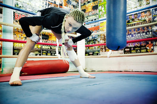 Female boxer doing stretching before workout - Stock Image - Everypixel