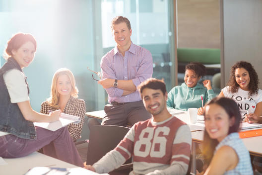 Professor and university students smiling in classroom - Stock Image ...
