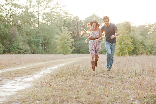 man and woman chasing each other in field - Stock Image - Everypixel